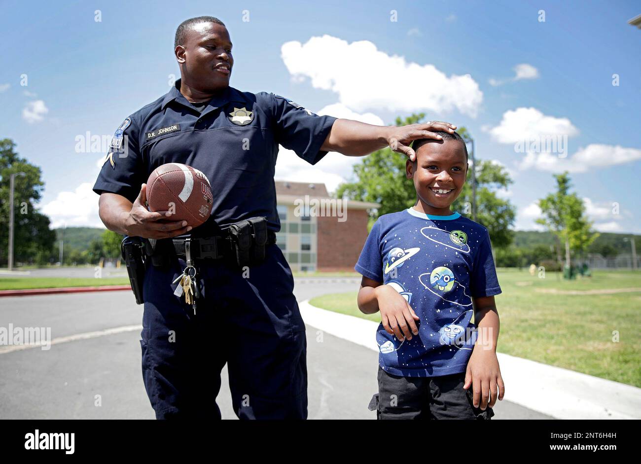 Tulsa Police Officer Donnie Johnson pats Errick Yance,8, on the head ...