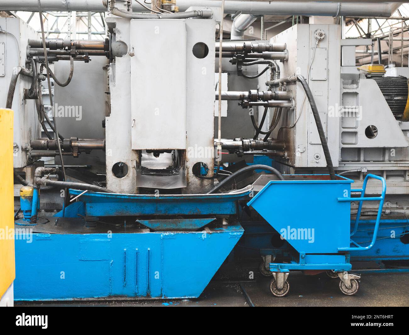Production machine and blue trolley at the workshop, selective focus ...