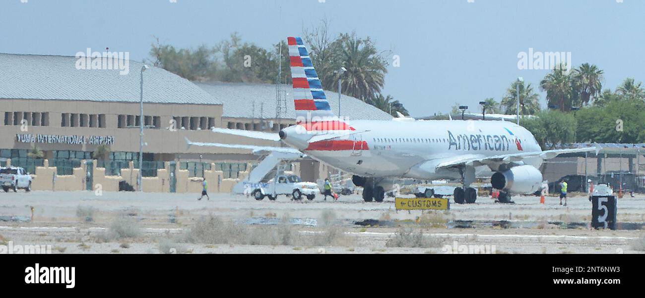 Yuma International Airport personnel work around an American Airlines ...