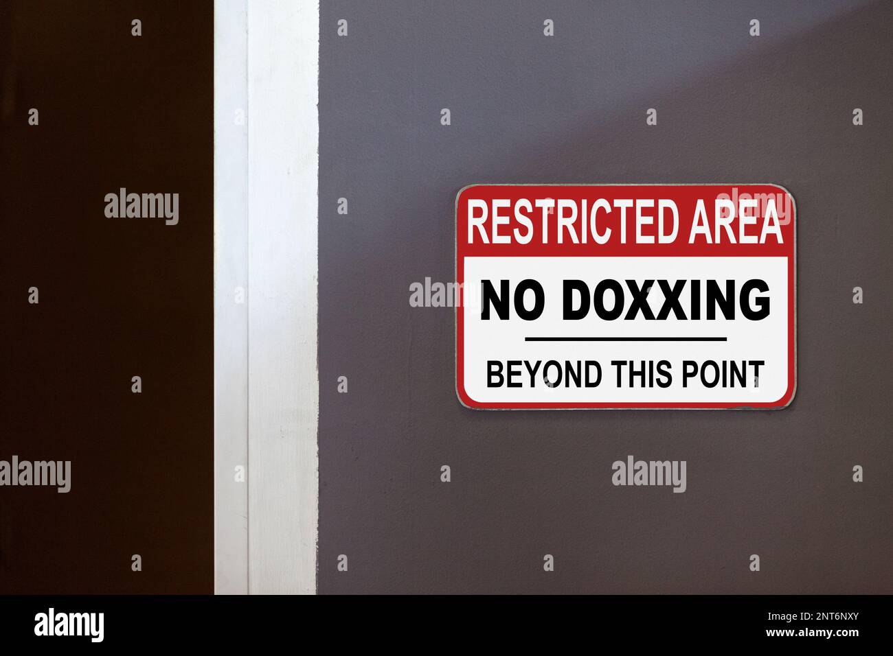 Red and white restricted area sign on the side of an open door stating ...