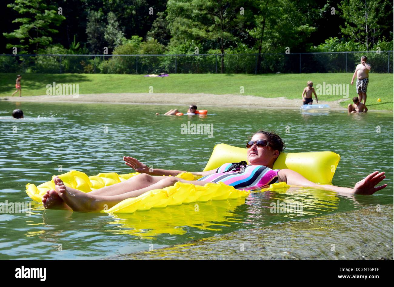 Tiffany Bennett, of Adams, Mass., floats in the cool waters of Margaret ...