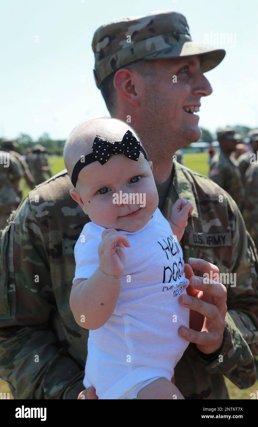 Sergeant Jason Calahan reacts to seeing his 4-month old daughter Zoey ...