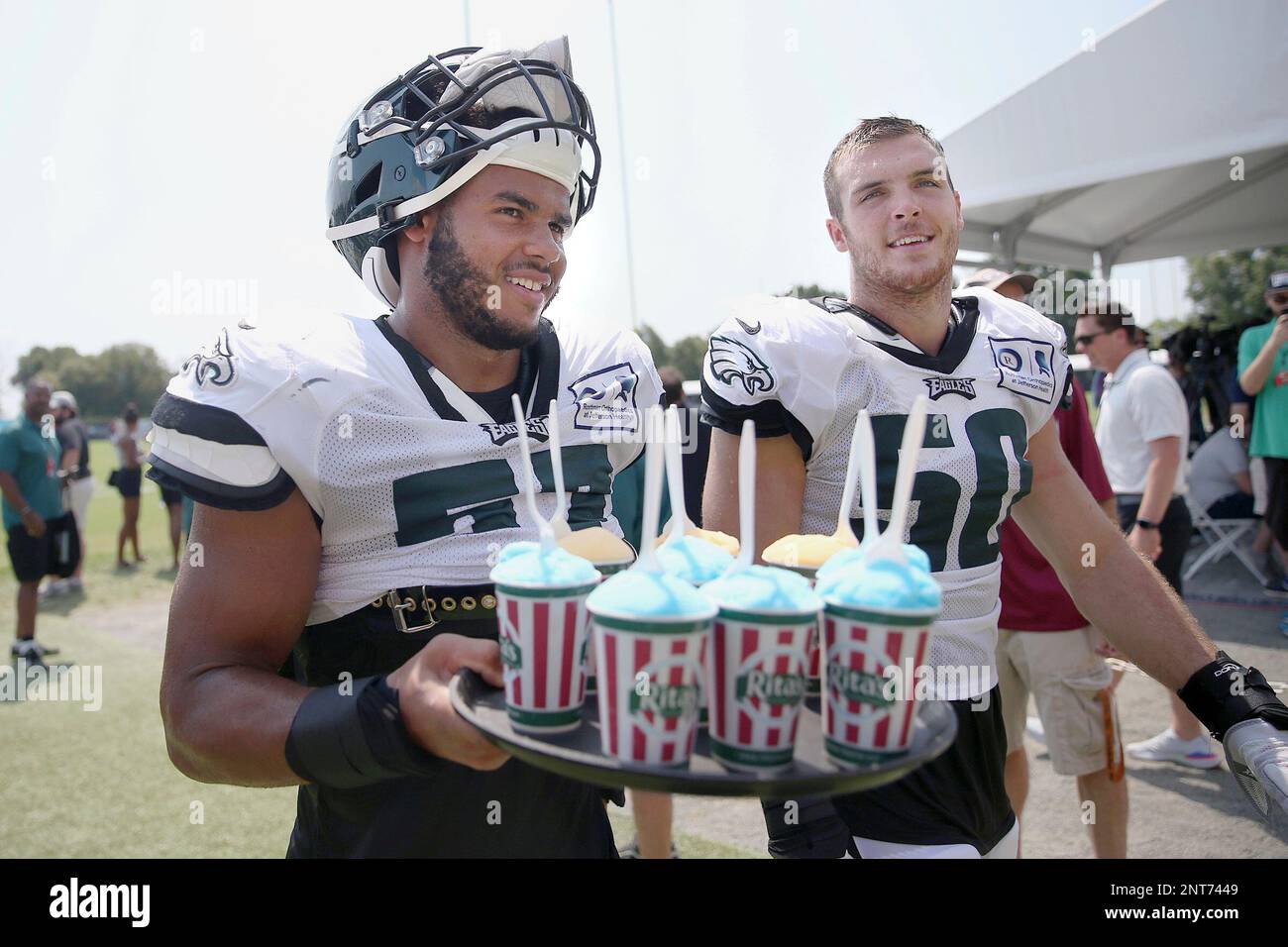 Linebacker T.J. Edwards, left, carries a tray of icewater as he and ...