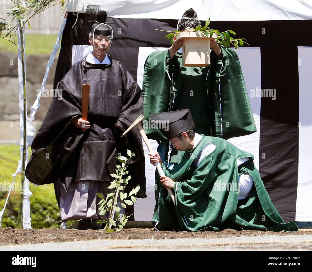 Shinto priests attend a ground-breaking ceremony at the Imperial Palace ...
