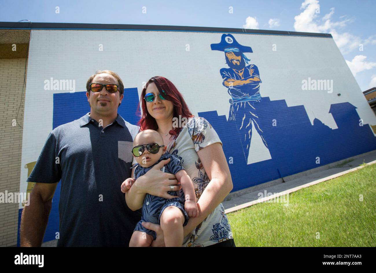 Artists Jeremy and Hannah Price, shown with their son, Maverick, pose ...