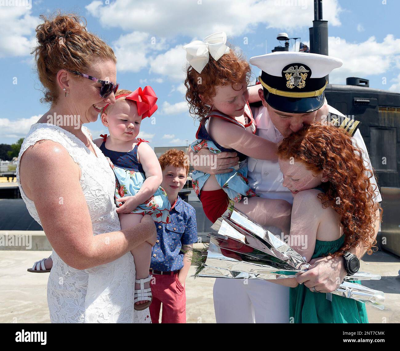 Lt. Cmdr. Steven Halle, Executive Officer, hugs his daughter Erin, 10 ...