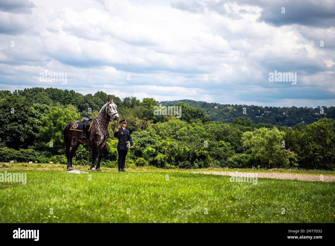 Mounted patrol Officer Justin Susich leads a riderless horse in the ...