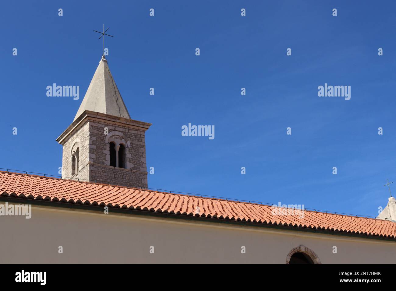 The bell tower, spire, Holy Cross & terracotta roof tiles of Sveti ...