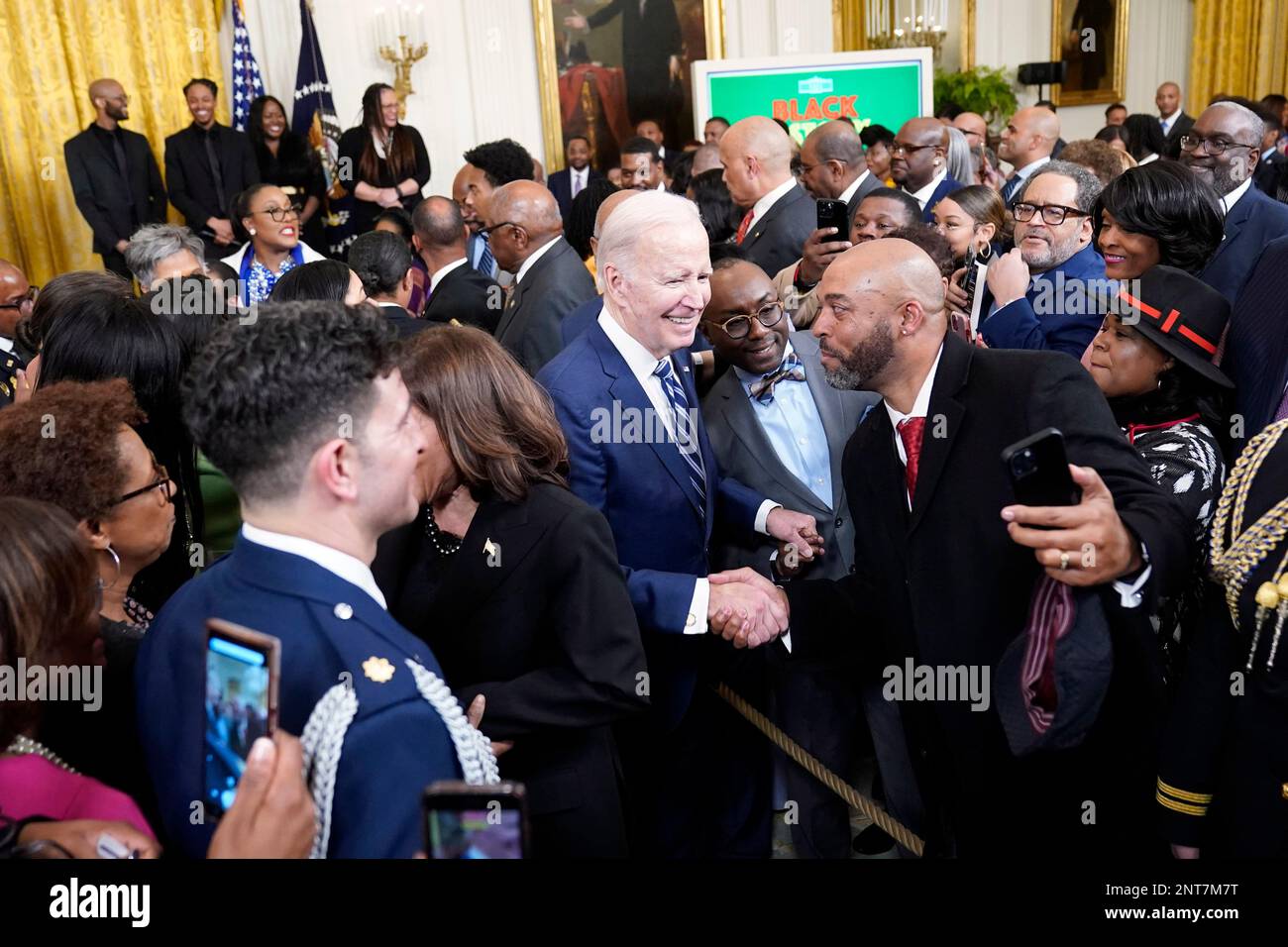 President Joe Biden greets guests as he leaves an event to celebrate ...