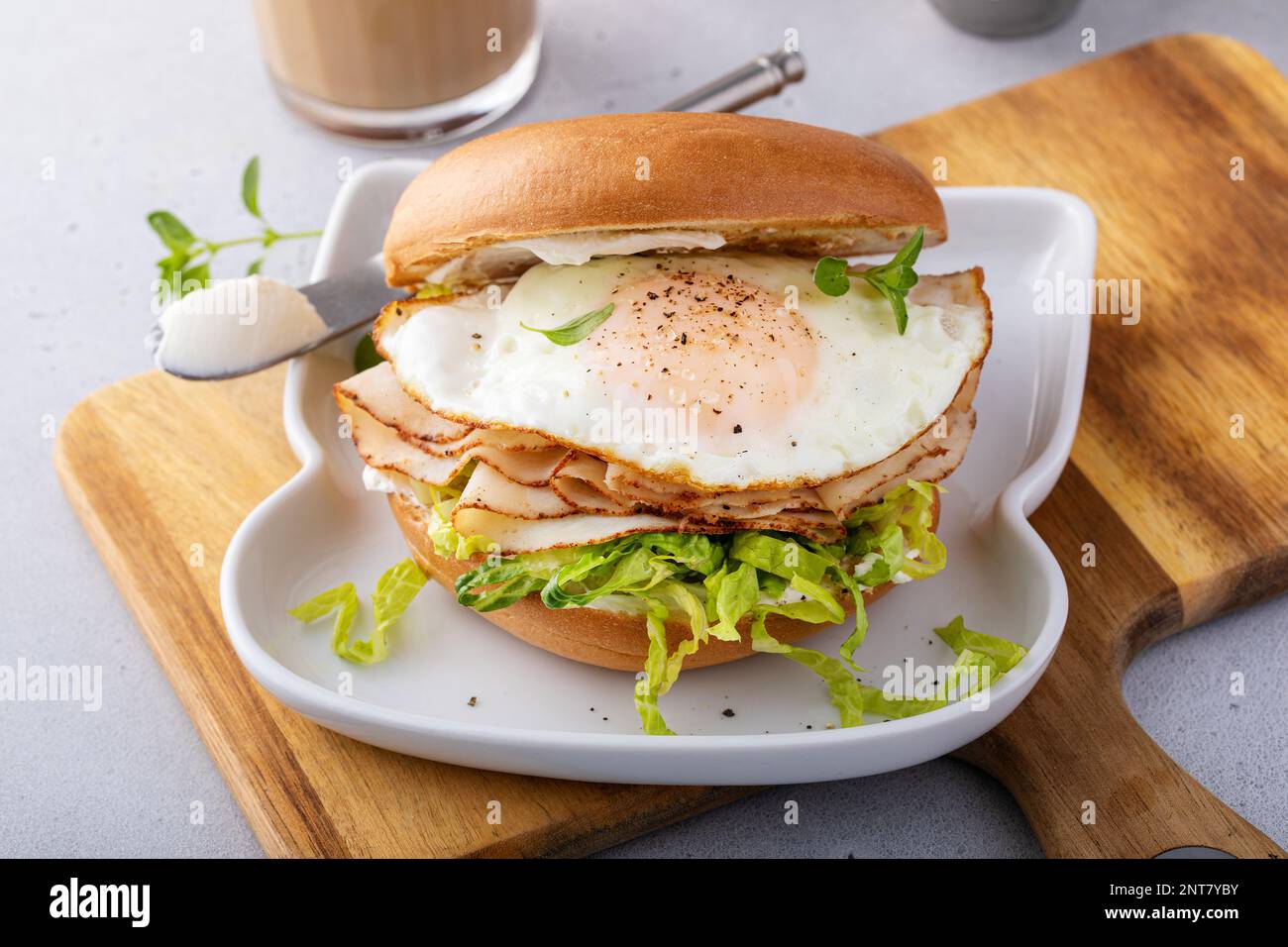 Bagel with cream cheese, shredded lettuce, sliced turkey and fried egg ...