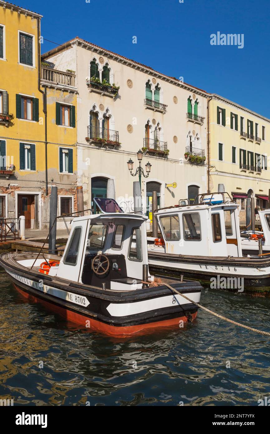 Moored boats and old Renaissance architectural style palaces and ...