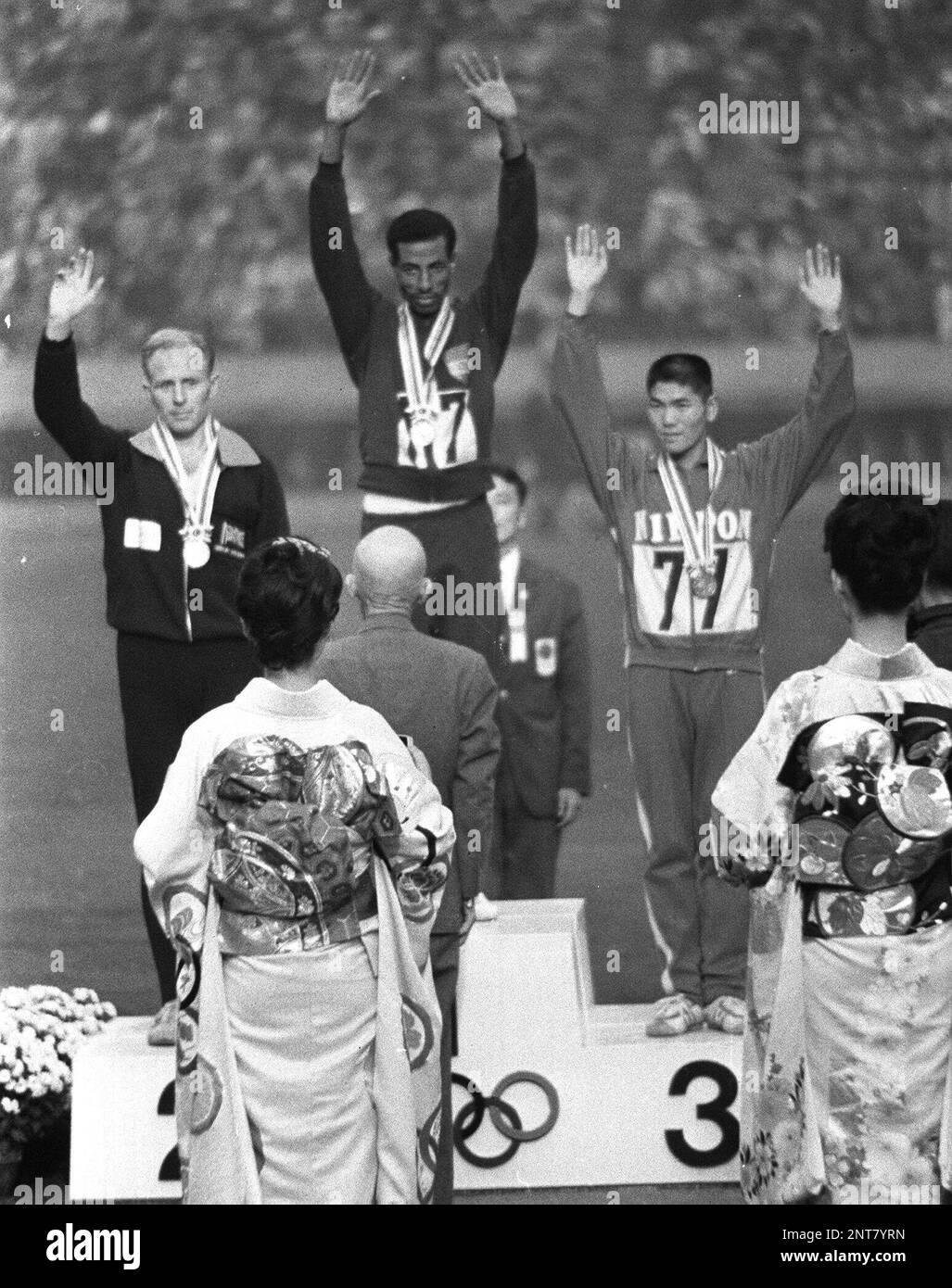 (L to R) Basil Heatley of Great Britain, silver, Abebe Bikila of ...