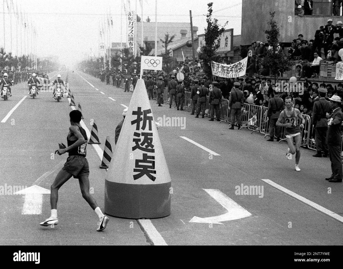 Abebe Bikila of Ethiopia (L) competes during the Marathon in Tokyo ...
