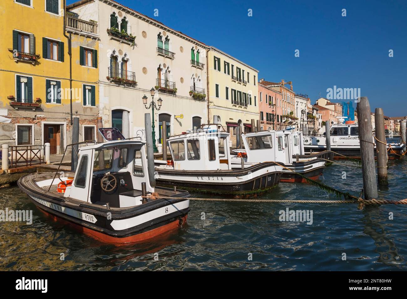 Moored boats and old Renaissance architectural style palaces and ...