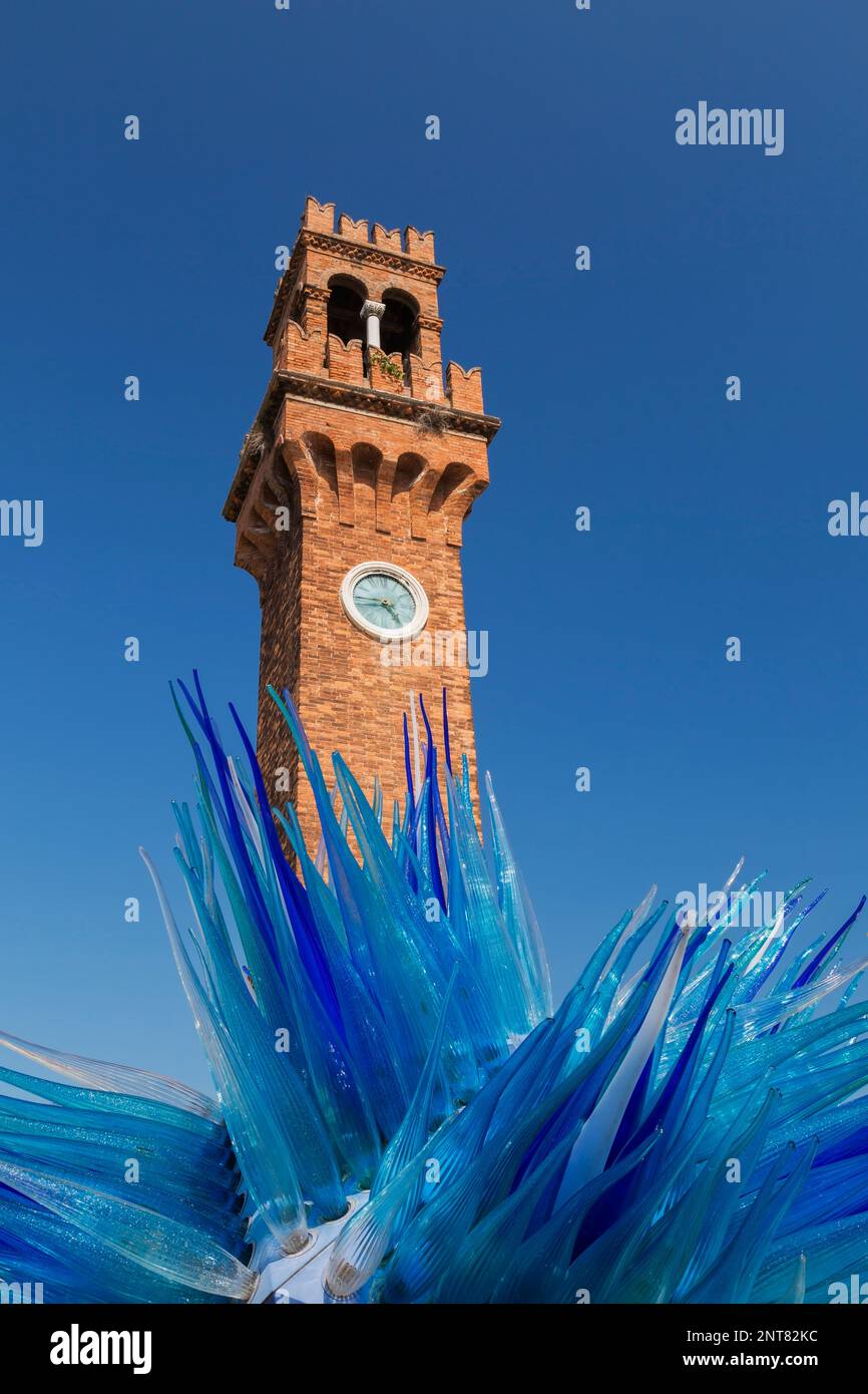 Blue Murano glass sculpture and red brick medieval clock tower in San ...