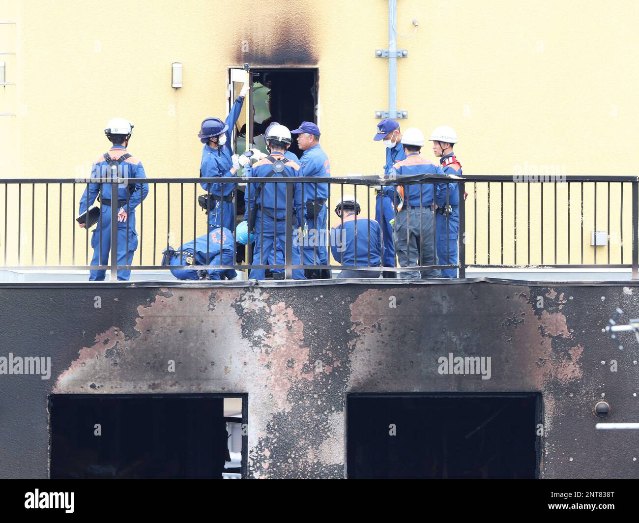 Officers conduct an investigation at the arson site of Kyoto Animation ...