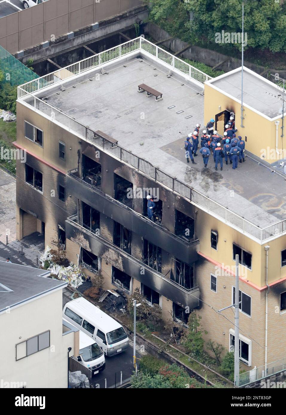 An aerial photo shows officials conduct an investigation at the arson ...