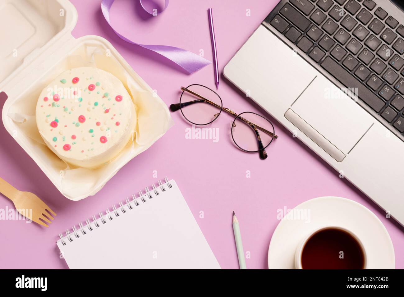 Office desk with notepad computer supplies cup of coffee bento cake ...