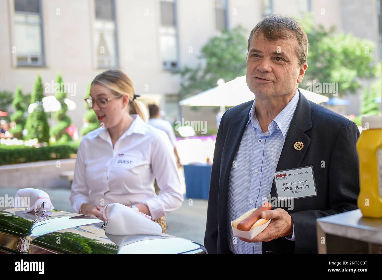 UNITED STATES - JULY 17: Rep. Mike Quigley, D-Ill., grabs a hot dog ...