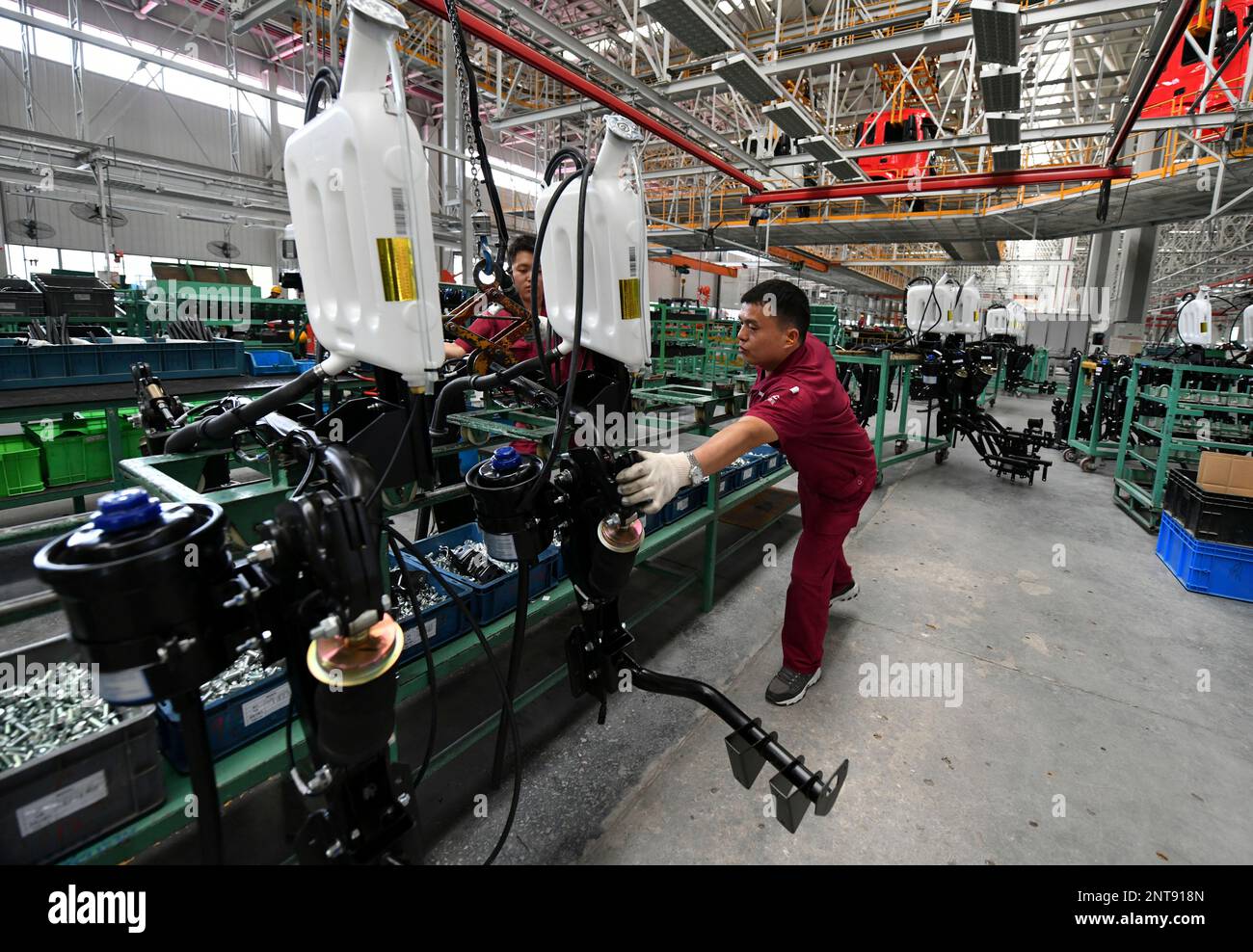 People work on the assembly line of JAC trucks in Fuyang in central ...