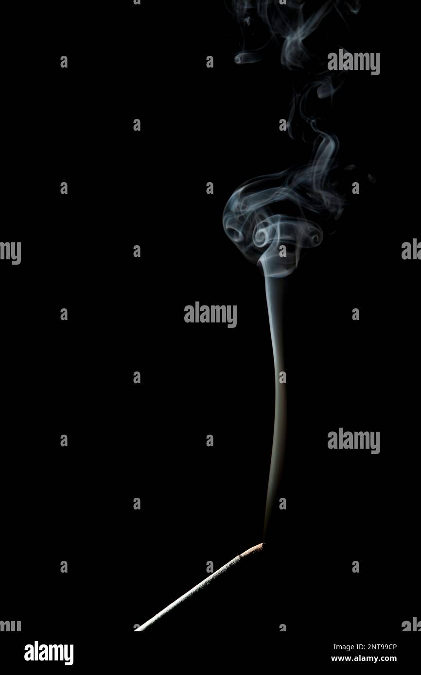 Burning incense stick and its smoke on a black background Stock Photo ...