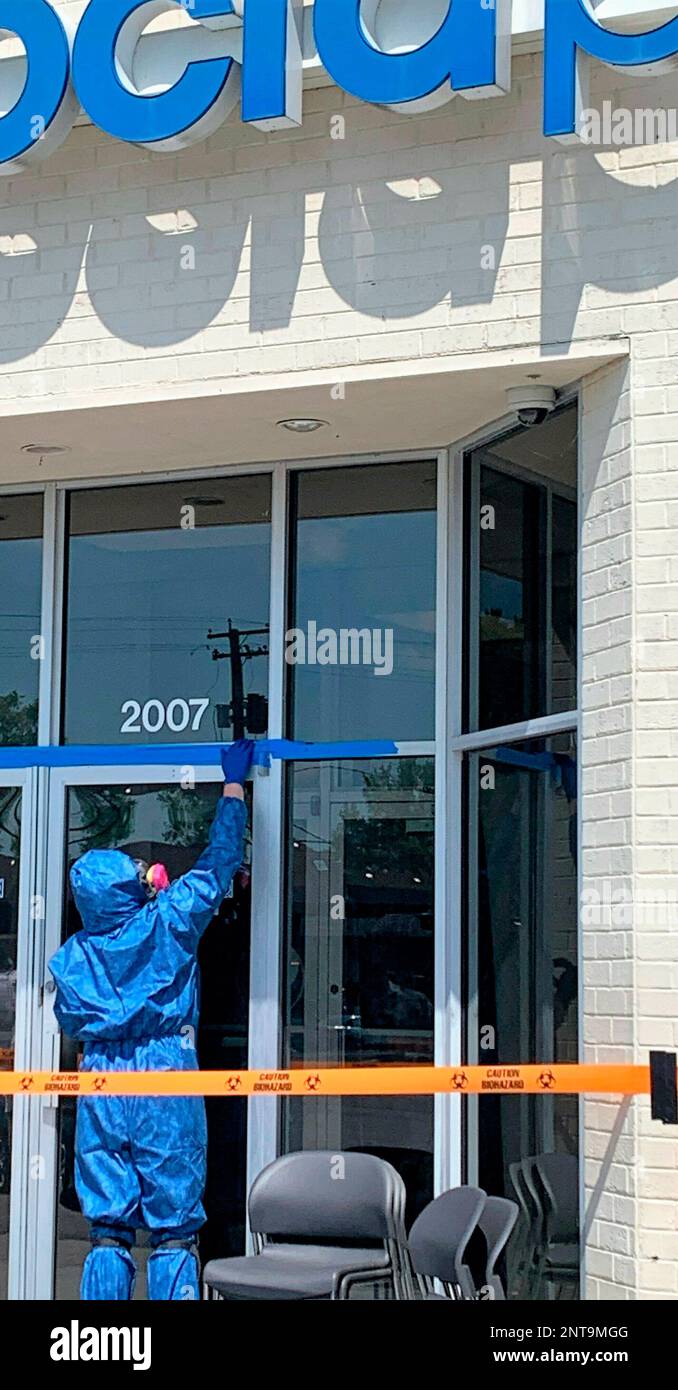 An employee of Aftermath Services in Richmond seals the entrance to ...