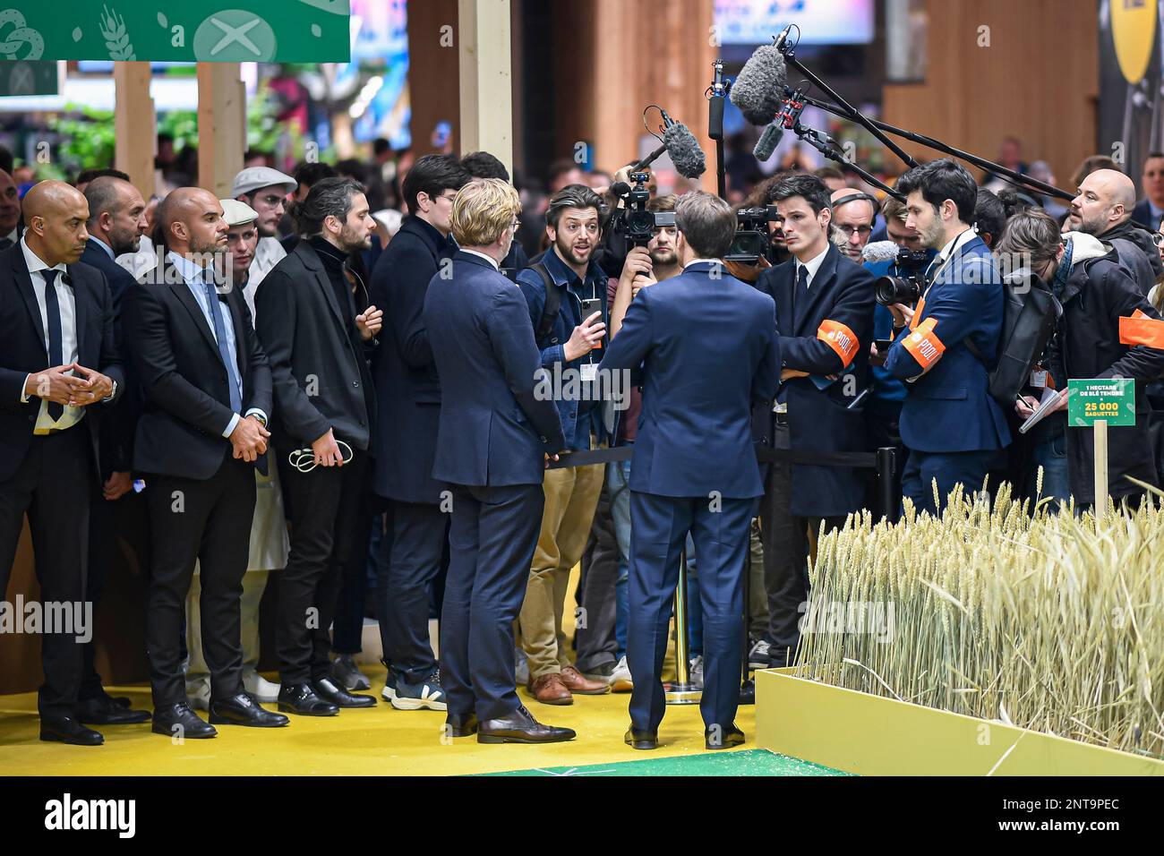 Journalist Paul Larrouturou and French President Emmanuel Macron during ...
