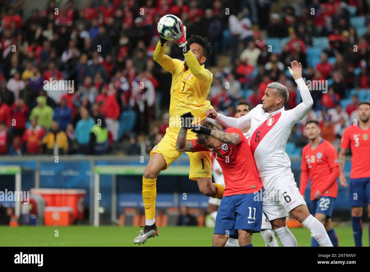 Peru's goalkeeper Pedro Gallese, top, catches the ball over Chile's ...