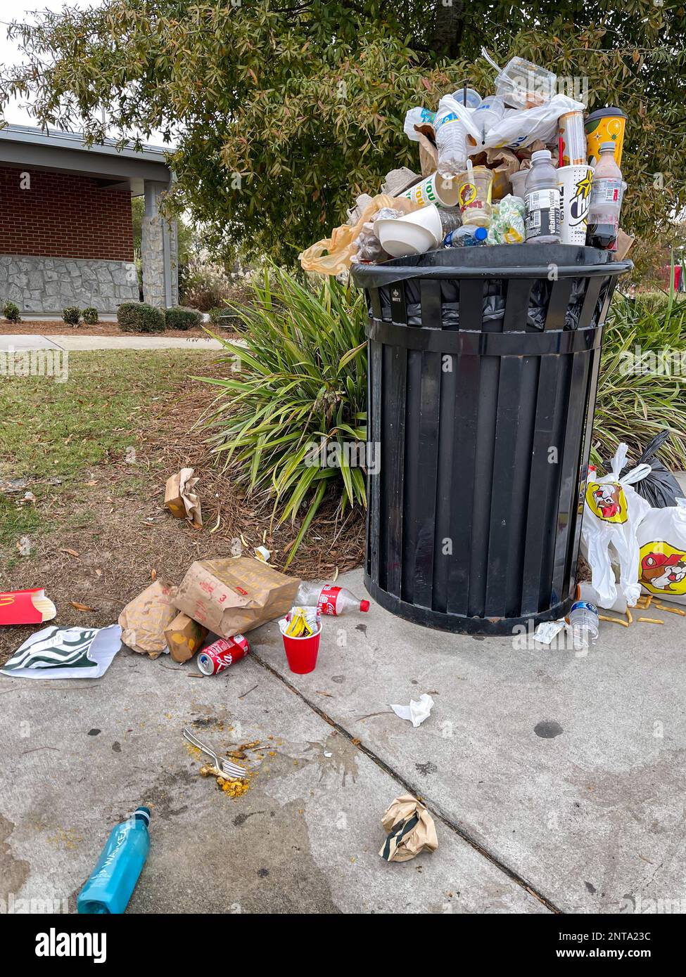 Unadilla, GA / USA - November 20, 2022: A trash can overflows with ...