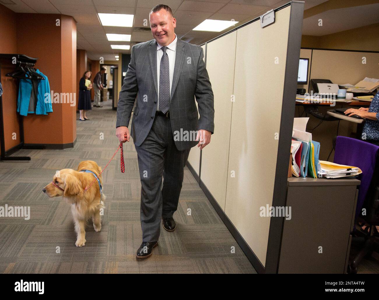 Bill Kube, a victim/witness advocate, walks Norie, the Ramsey County ...