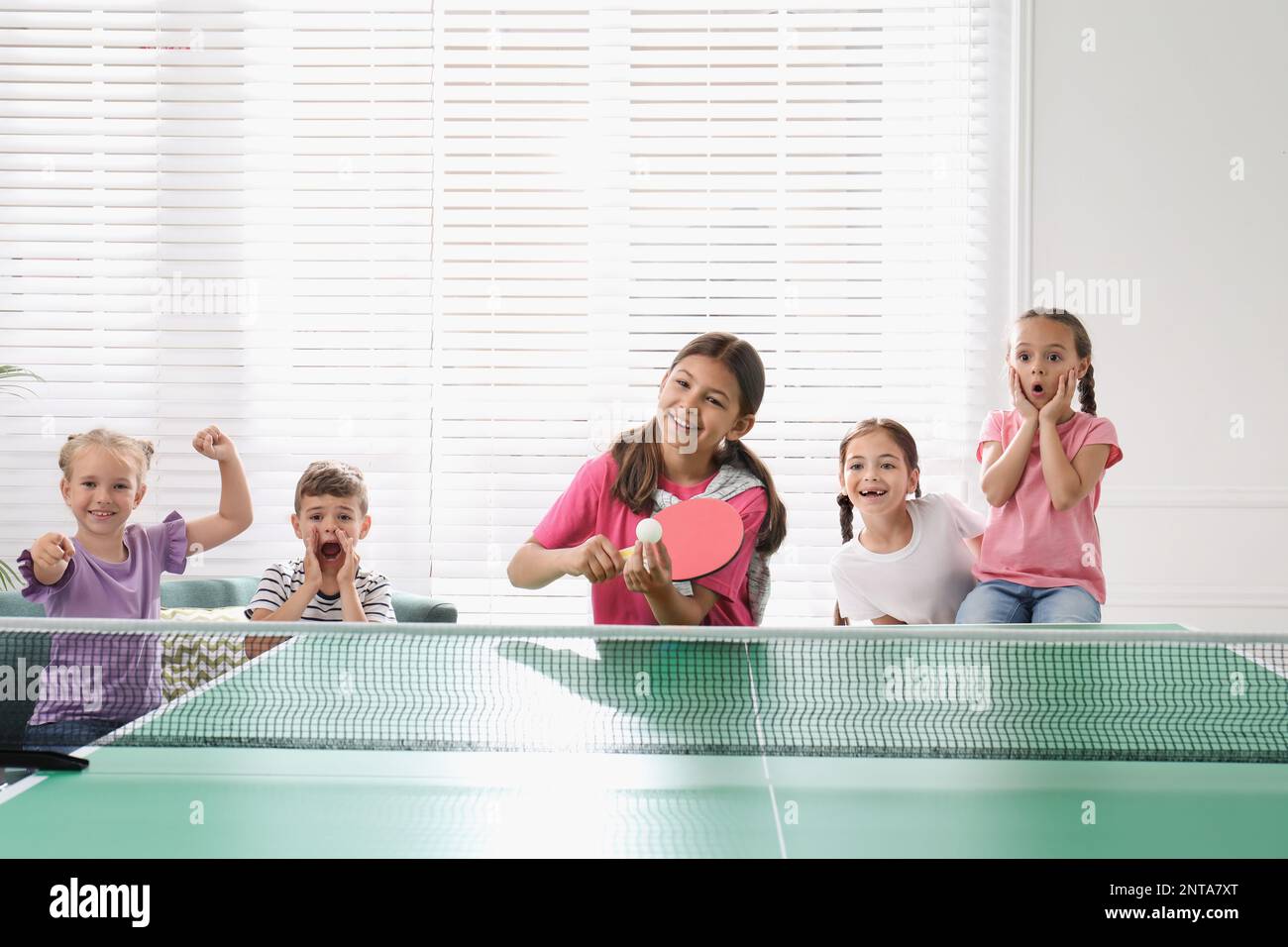 Cute happy children playing ping pong indoors Stock Photo - Alamy