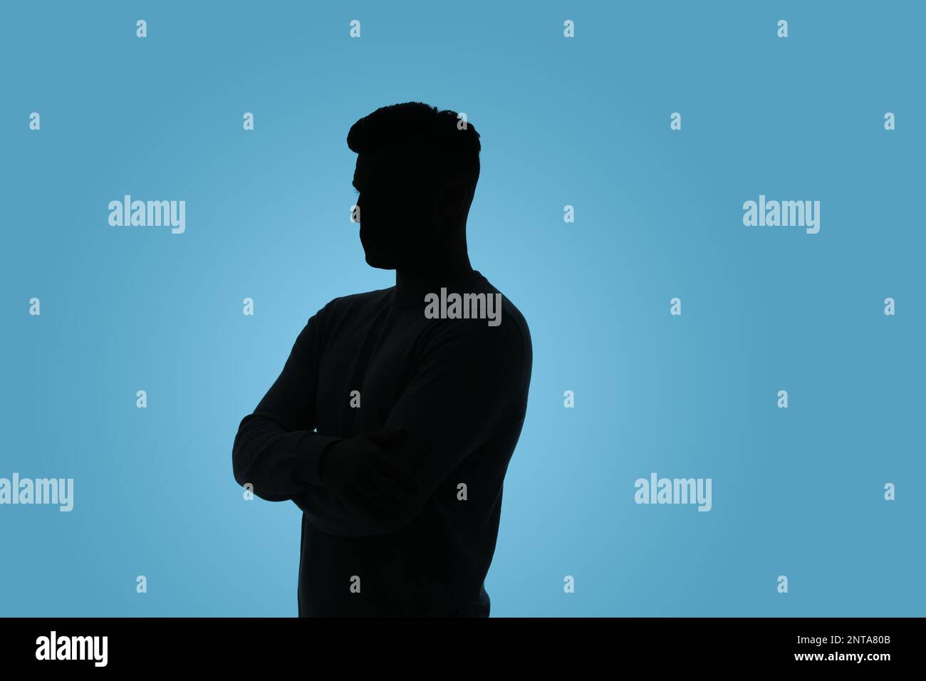 Silhouette of anonymous man on light blue background Stock Photo - Alamy