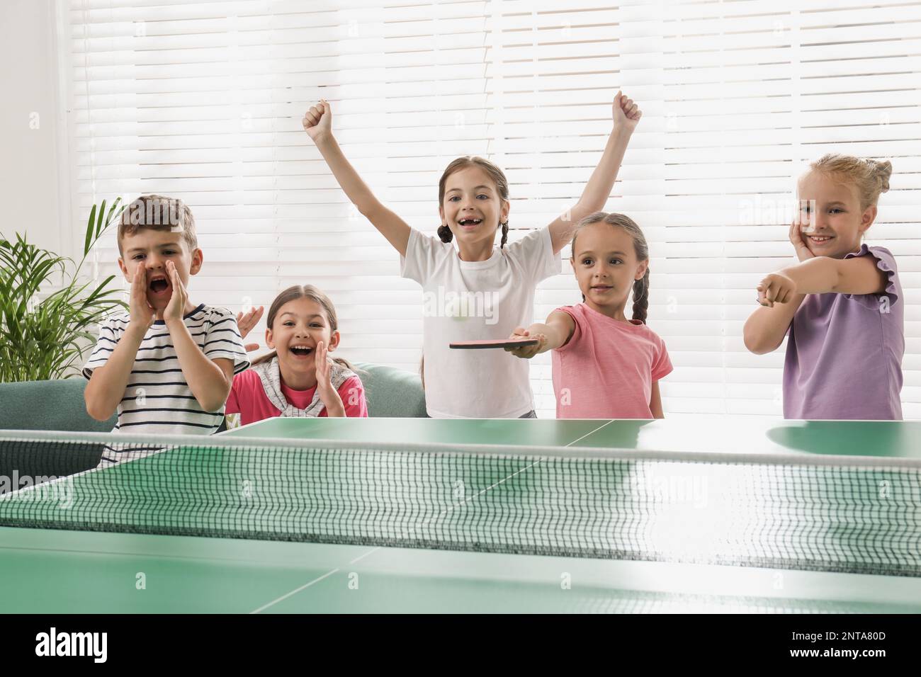Cute happy children playing ping pong indoors Stock Photo - Alamy