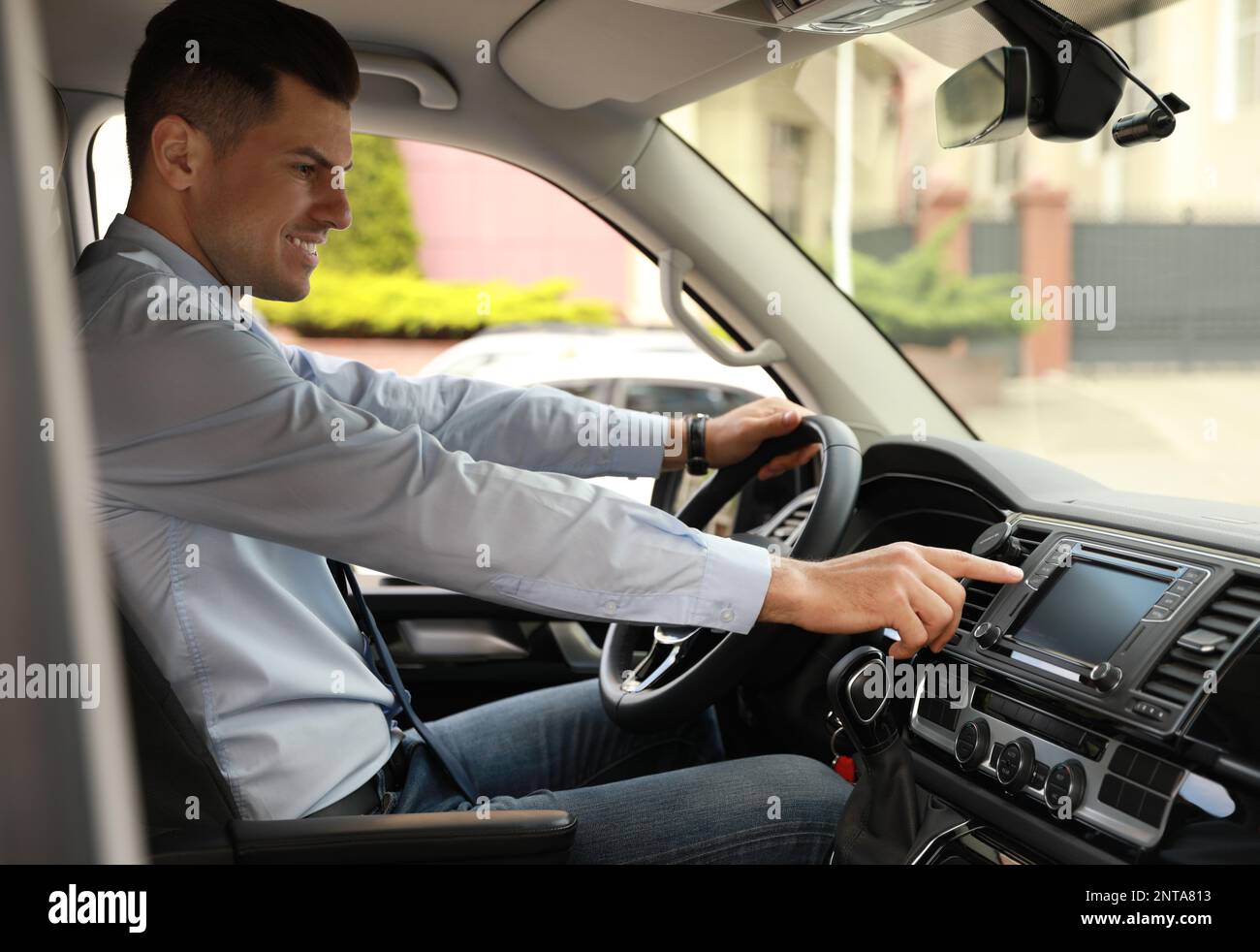 Man using navigation system while driving car Stock Photo - Alamy