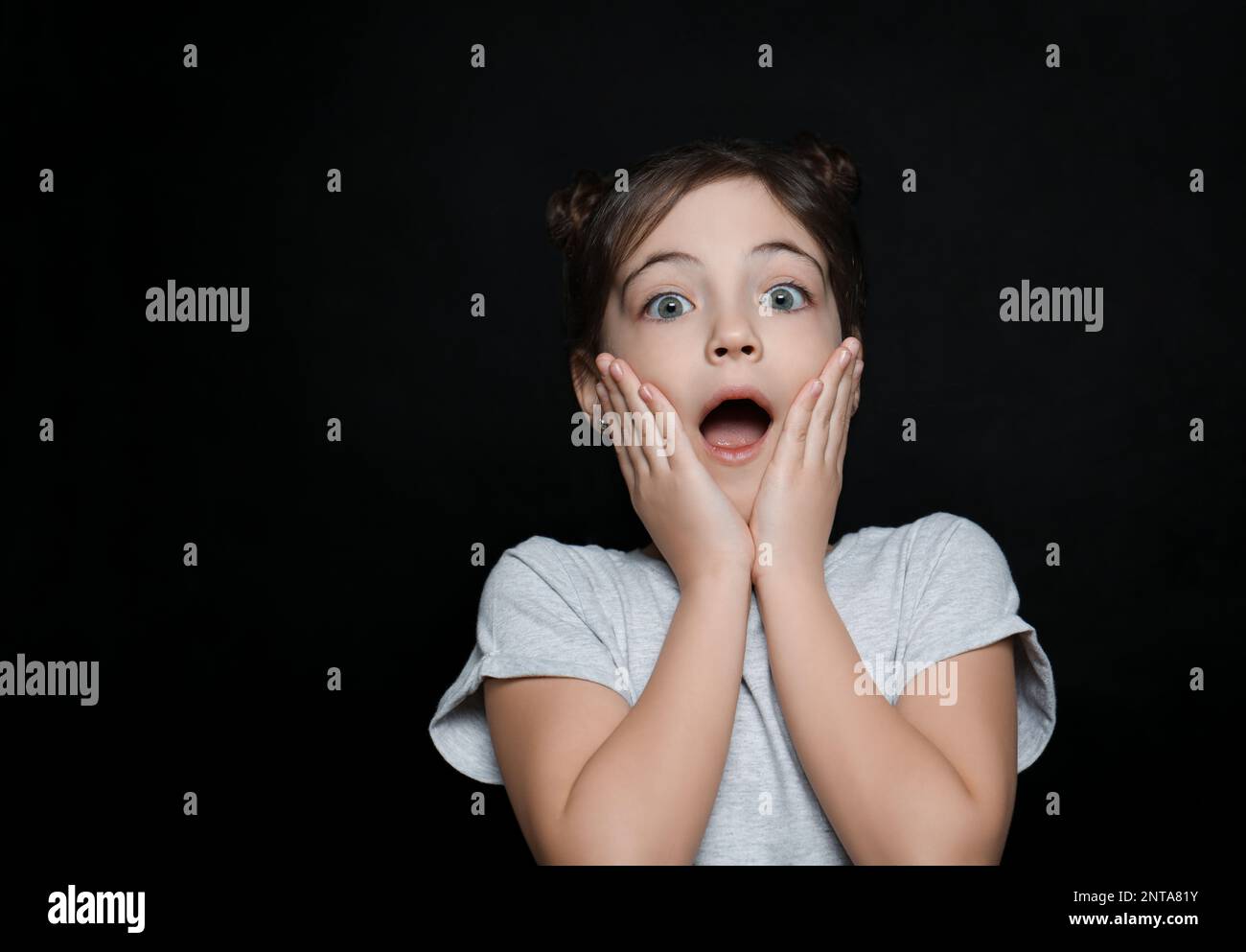 Little girl feeling fear on black background Stock Photo - Alamy