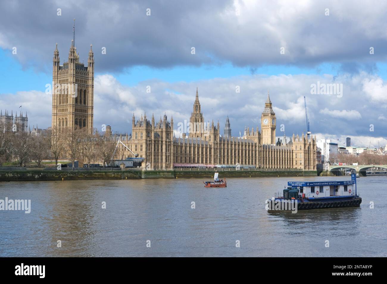 London, UK. A Viking longboat passes by the Houses of Parliament in an ...