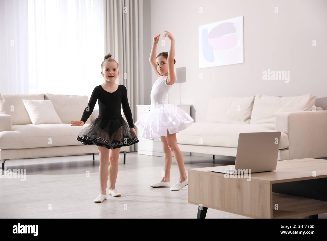 Cute little girls taking online dance class at home Stock Photo - Alamy