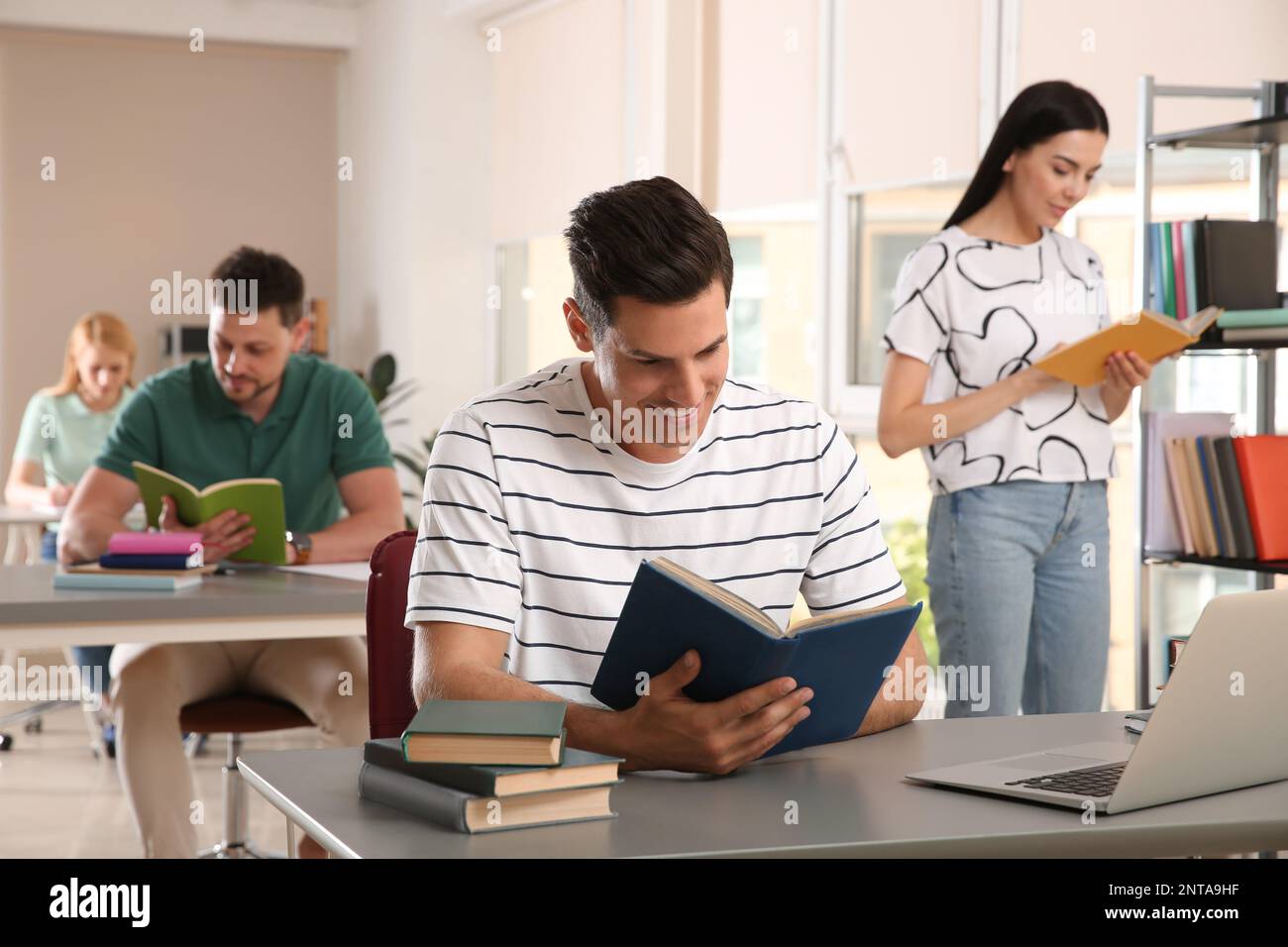 Students reading books and studying in library Stock Photo - Alamy
