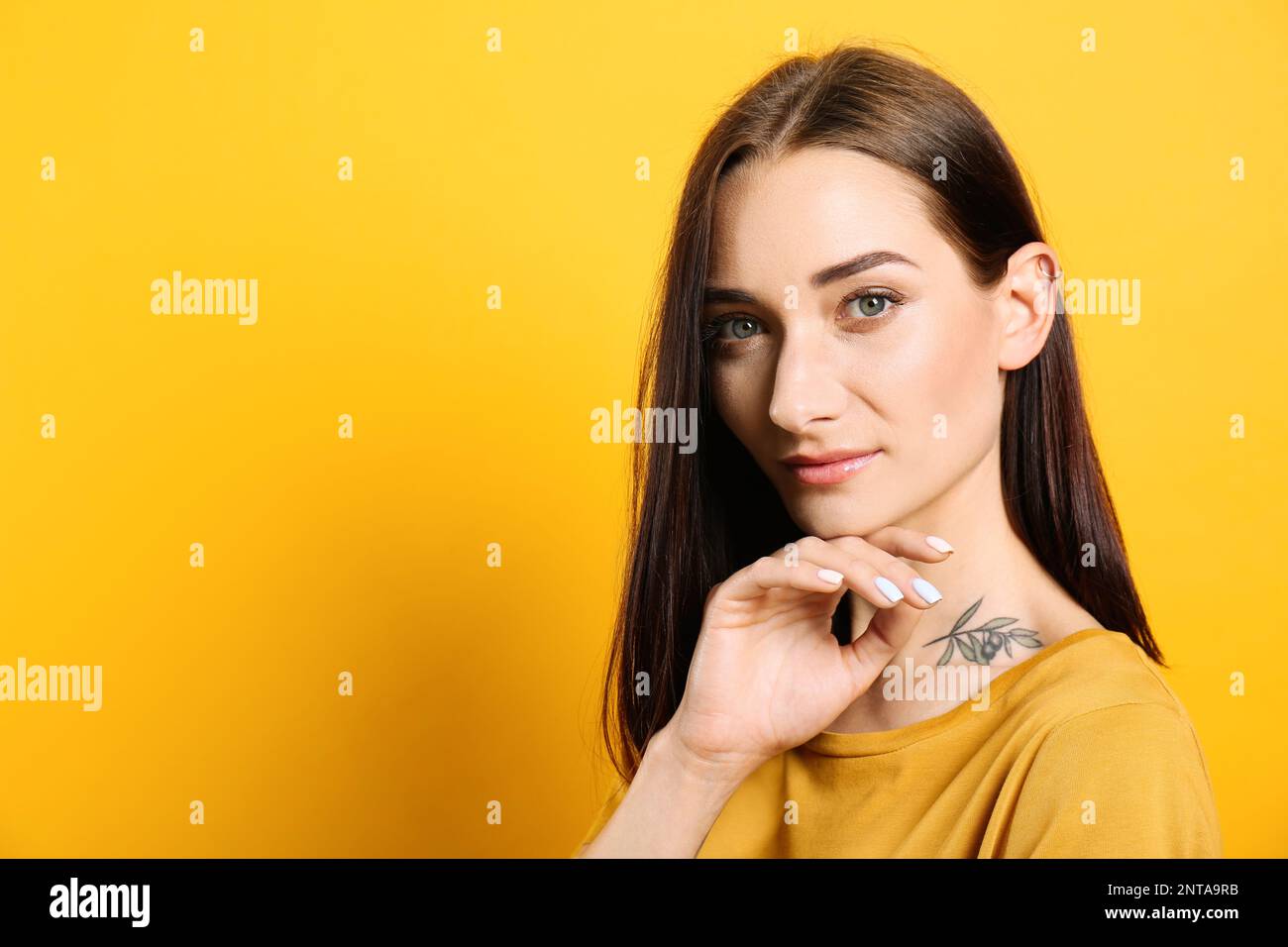 Portrait of pretty young woman with gorgeous chestnut hair on yellow ...