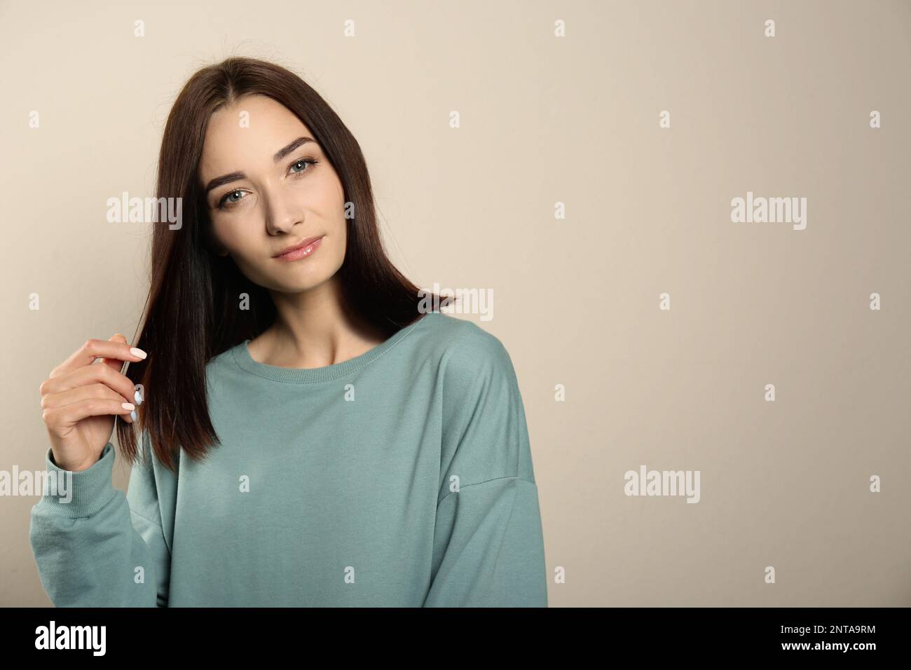 Portrait of pretty young woman with gorgeous chestnut hair on light ...