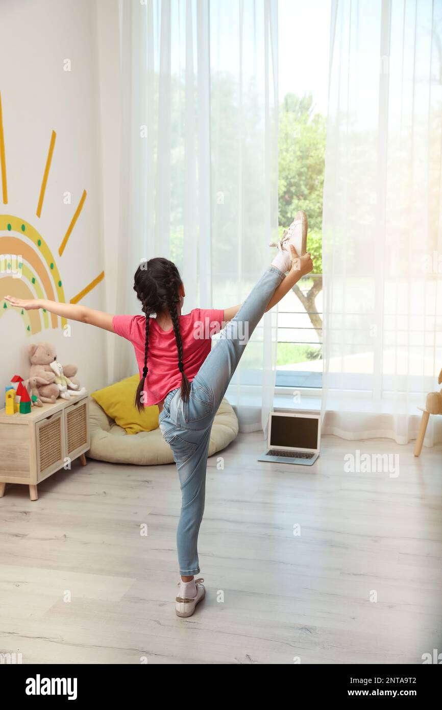 Cute little girl taking online dance class at home, back view Stock ...