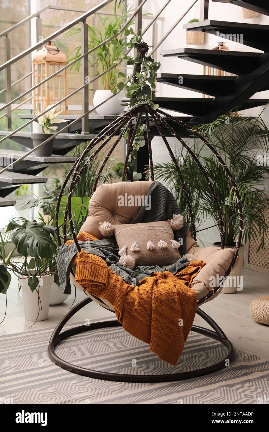 Indoor terrace interior with hanging chair and green plants Stock Photo ...