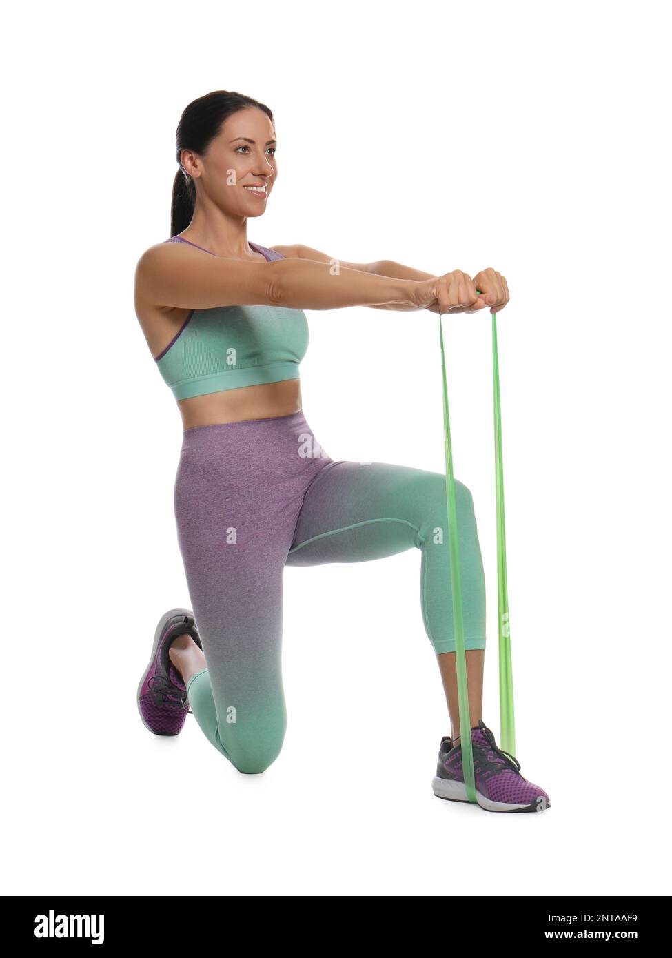 Woman doing sportive exercise with fitness elastic band on white ...