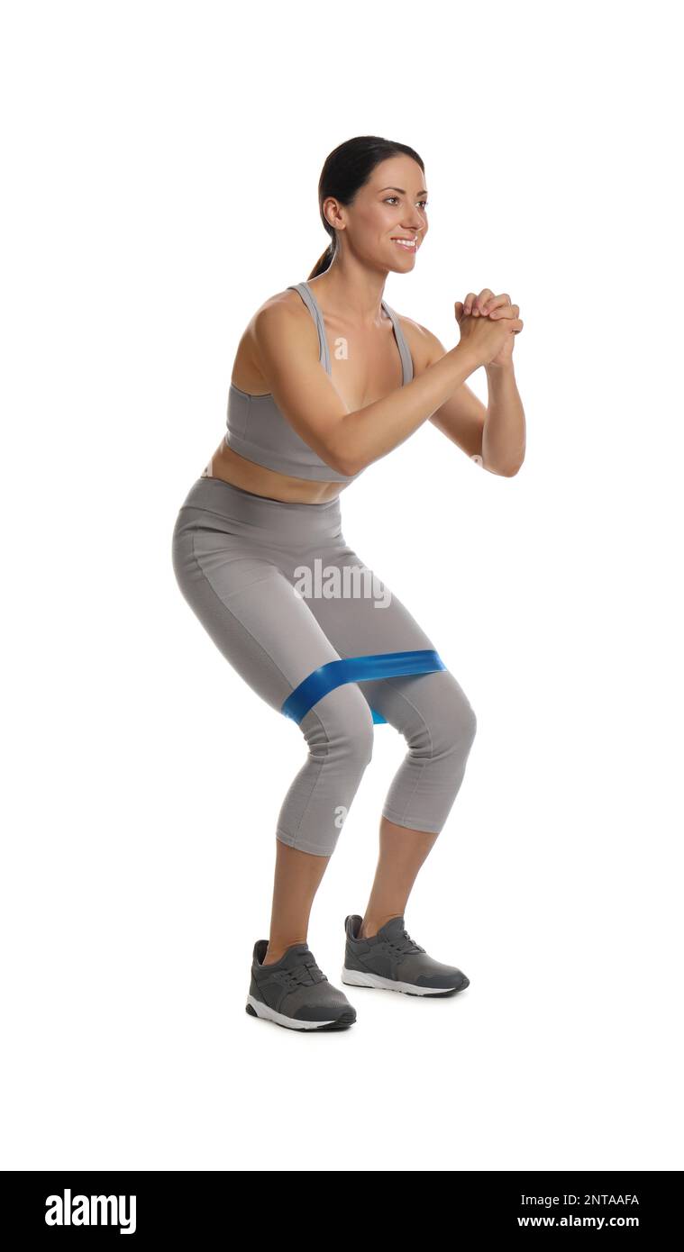 Woman doing squats with fitness elastic band on white background Stock ...