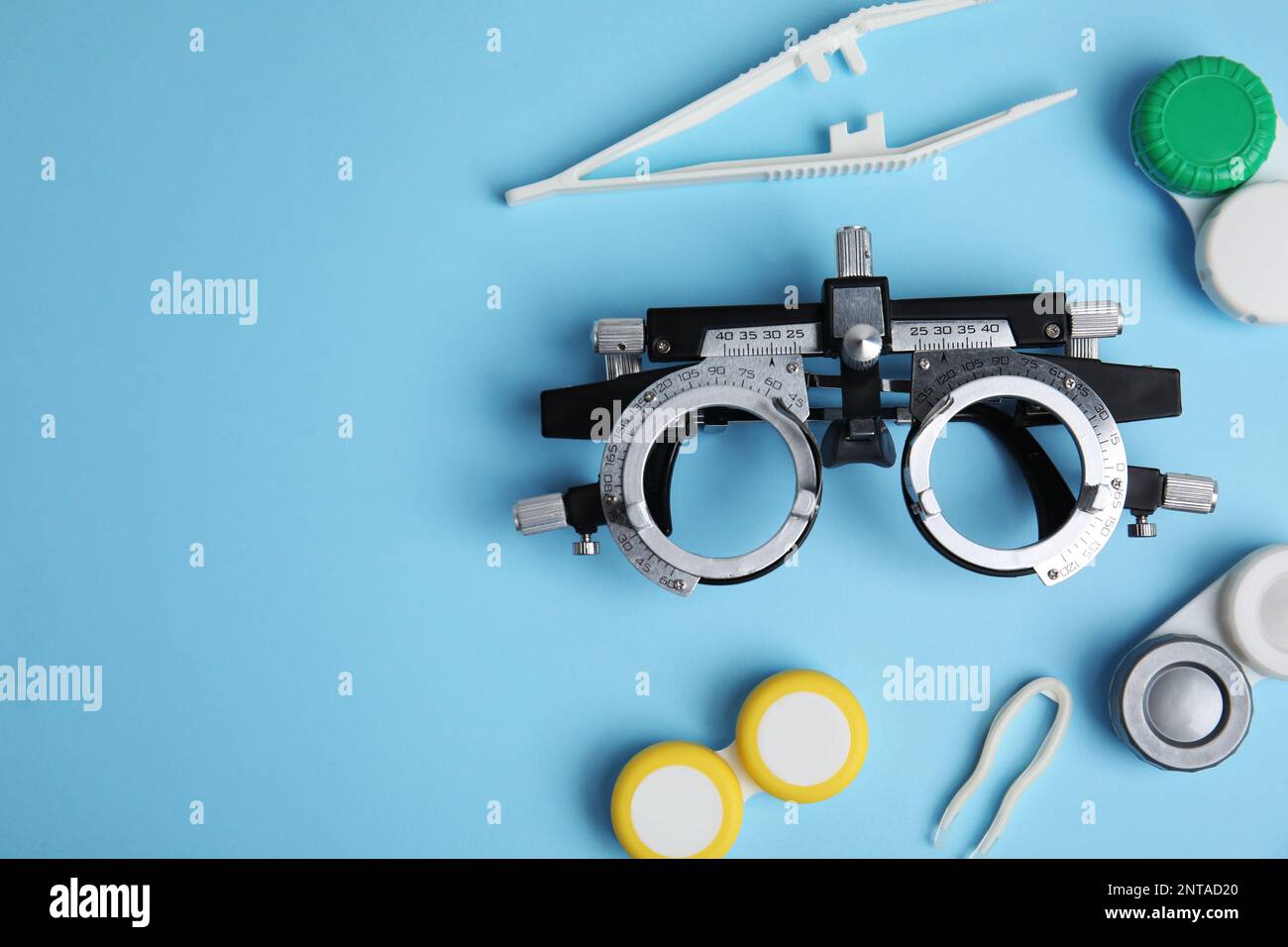 Different ophthalmologist tools on light blue background, flat lay ...