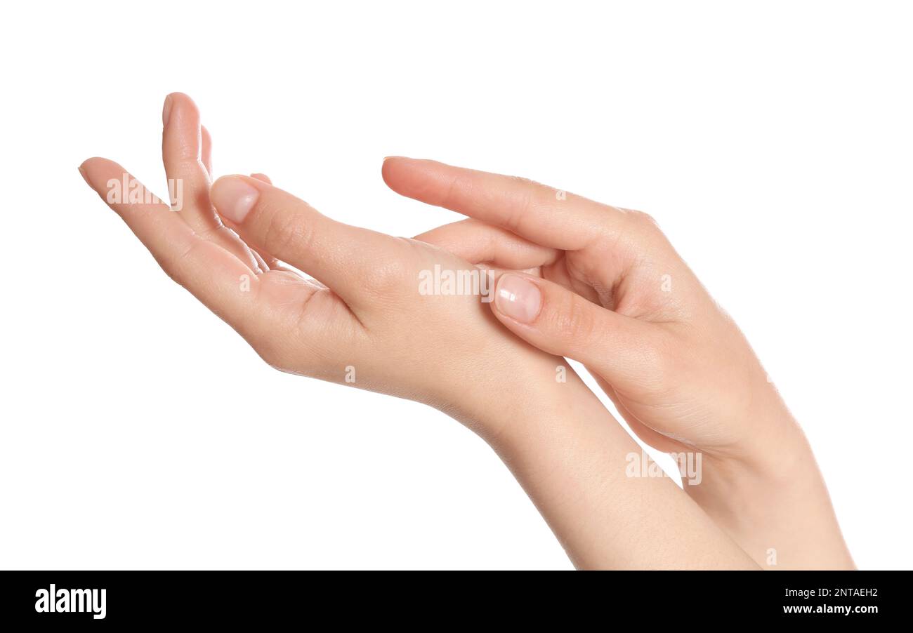 Young woman applying something onto her hands on white background ...