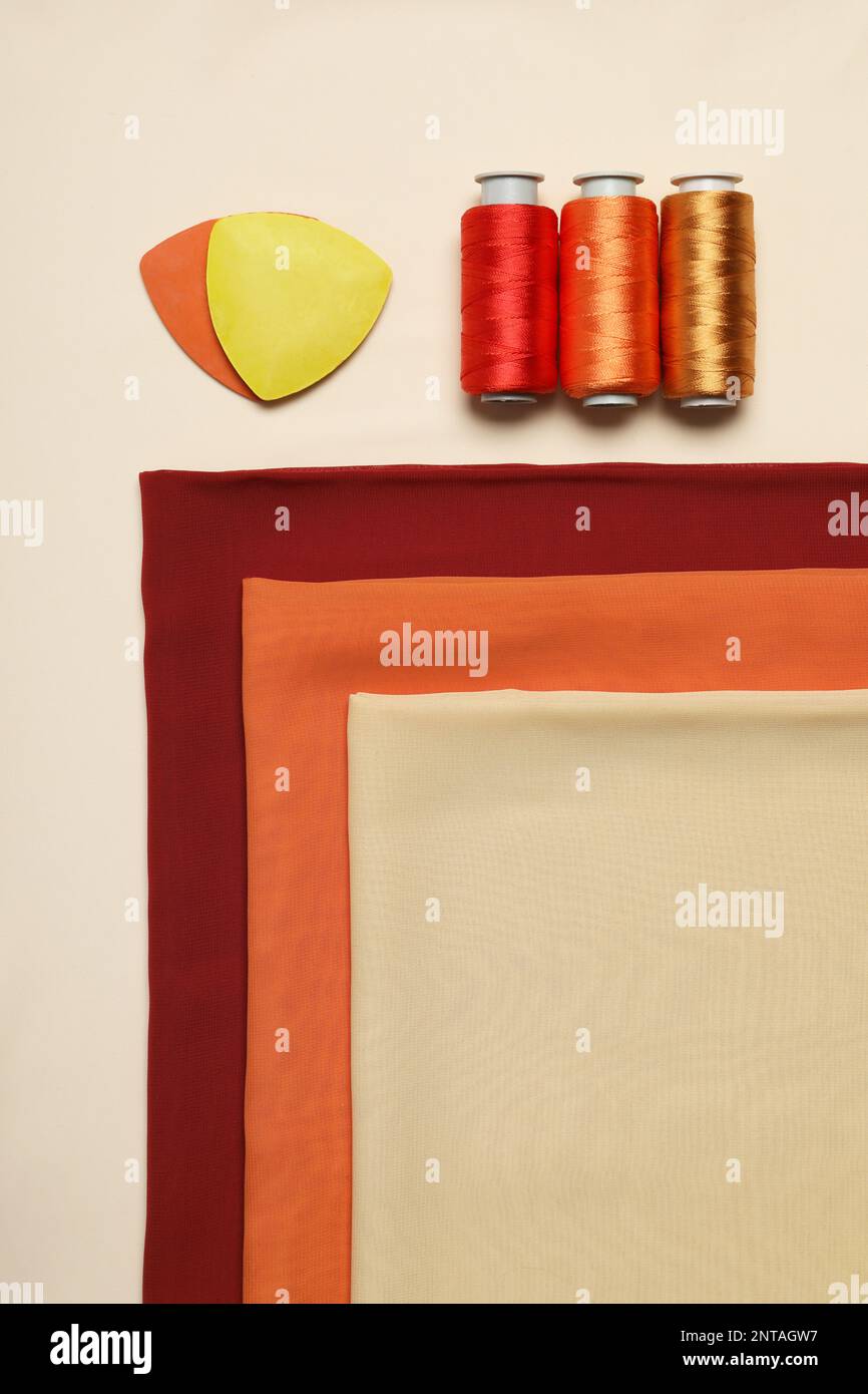 Flat lay composition with sewing threads on beige background Stock ...