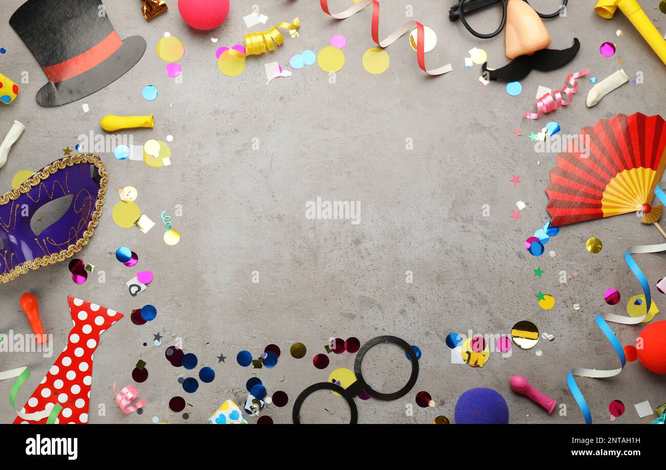Frame of carnival items on grey background, flat lay. Space for text ...