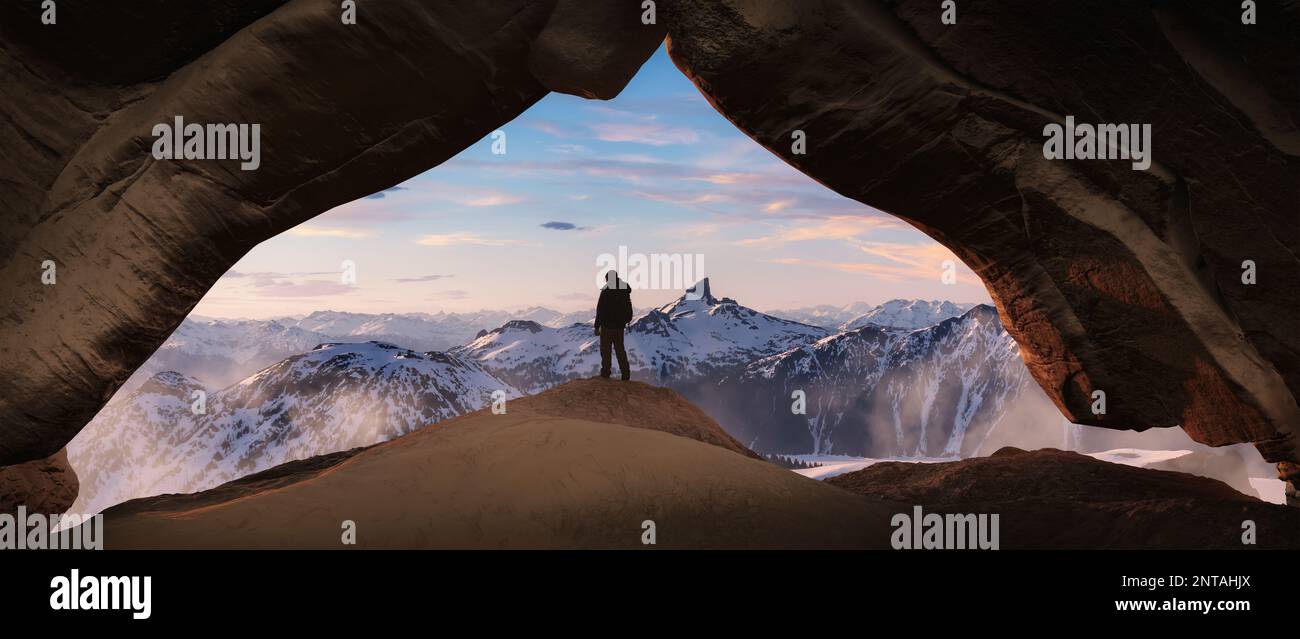 Adventurous Man Hiker standing in an Ice Cave with rocky mountains in ...
