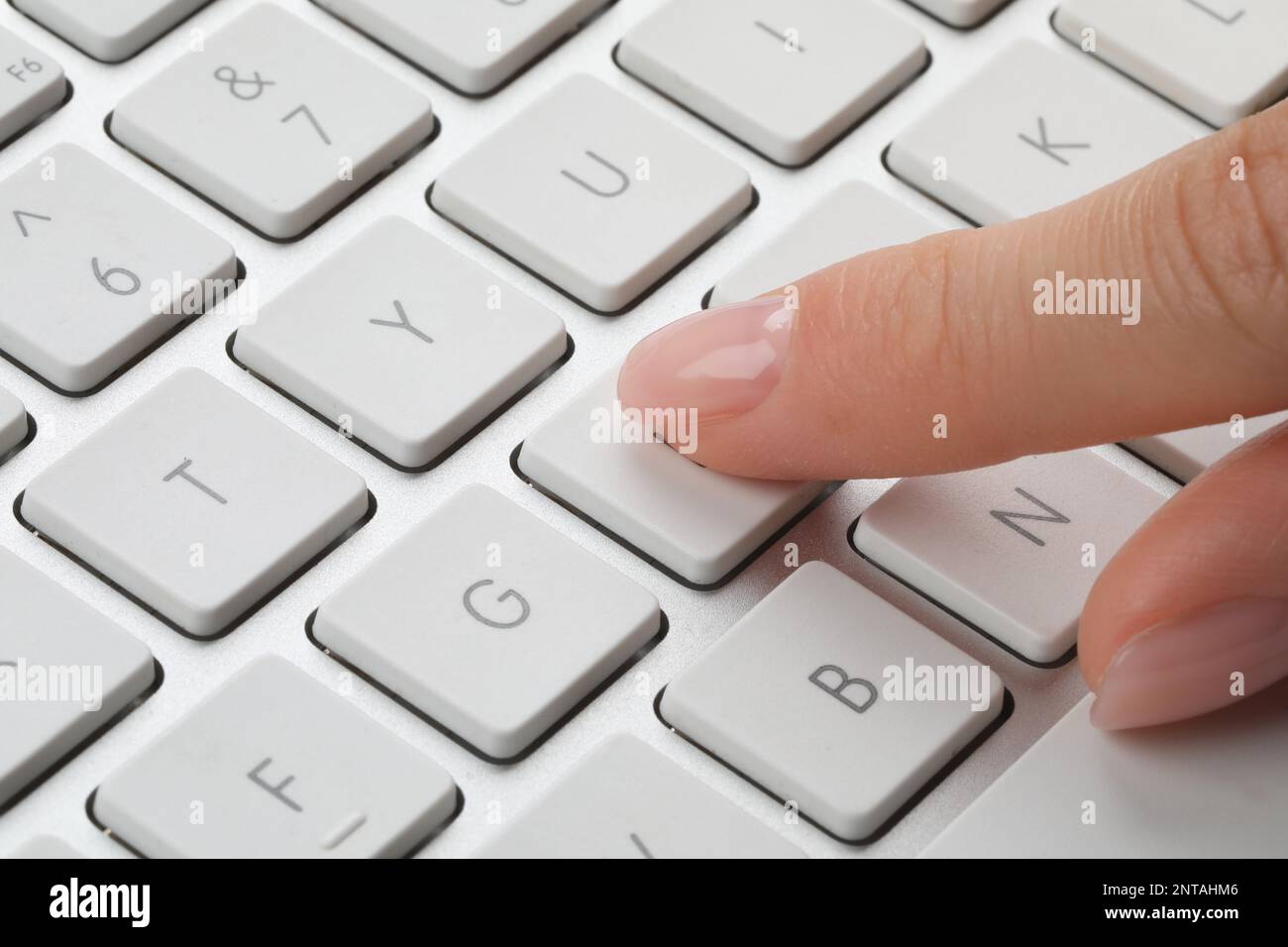Woman pressing button on computer keyboard, closeup Stock Photo - Alamy